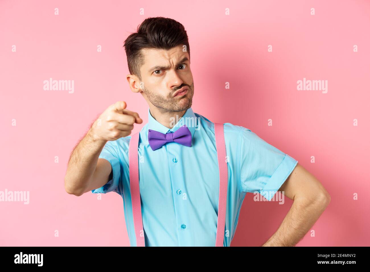 Grumpy guy in bow-tie and suspenders accusing you, its your fault ...