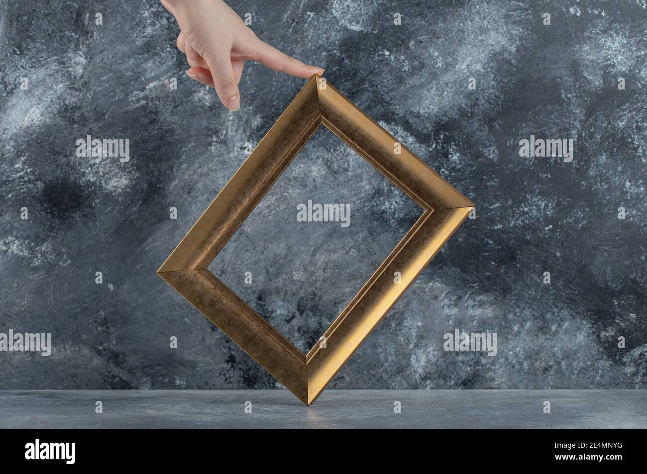 Female hand touching picture frame on marble background Stock Photo - Alamy