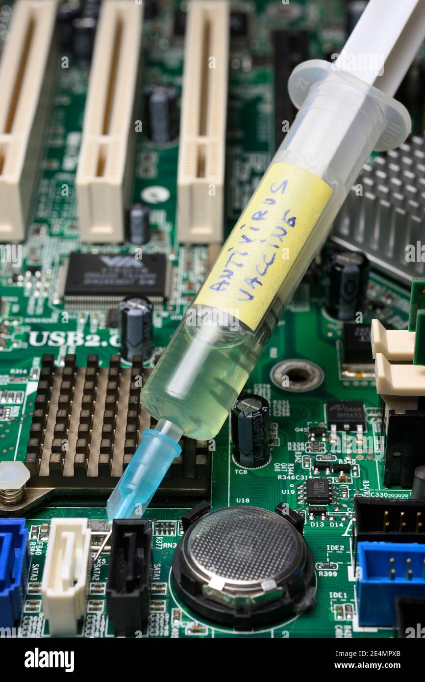 Syringe injection with antivirus vaccine into computer electronic board ...