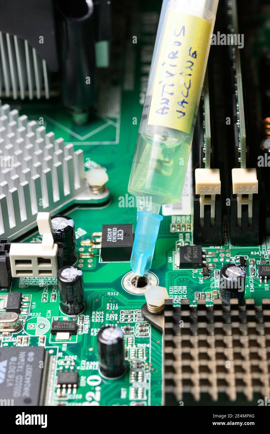 Syringe injection with antivirus vaccine into computer electronic board ...