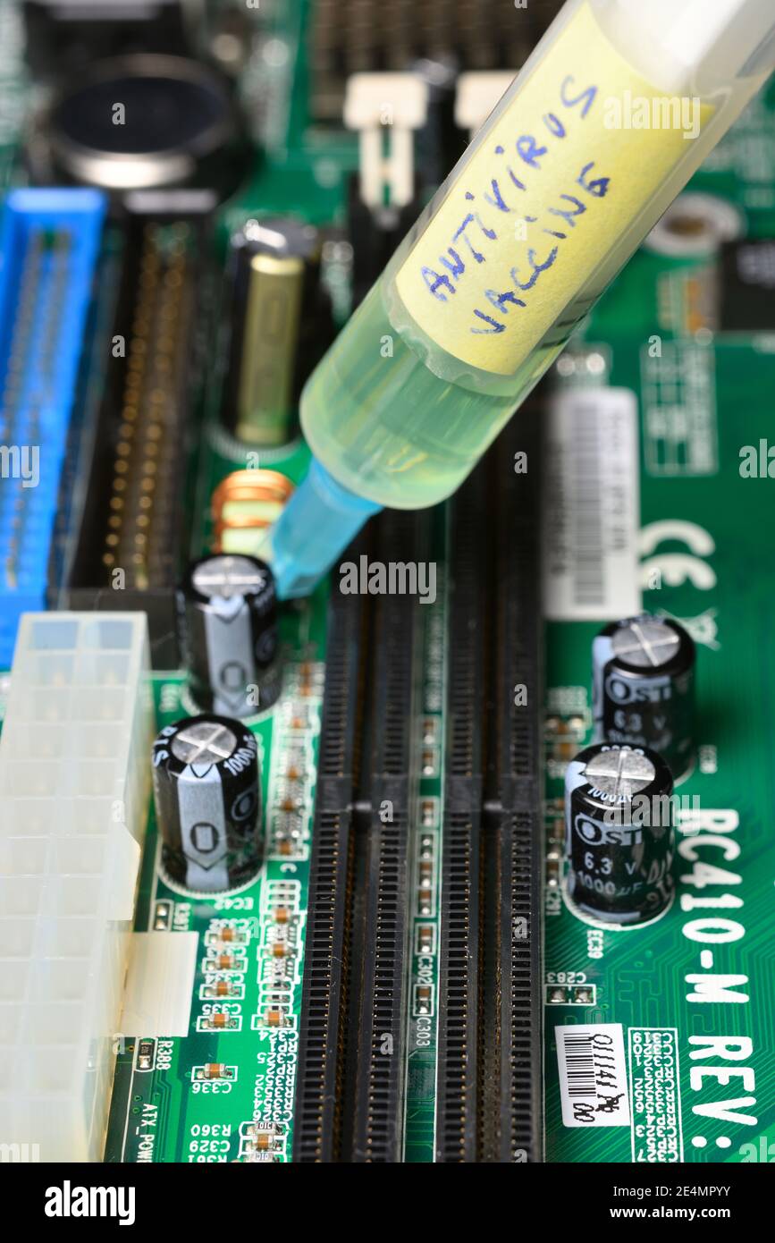 Syringe injection with antivirus vaccine into computer electronic board ...
