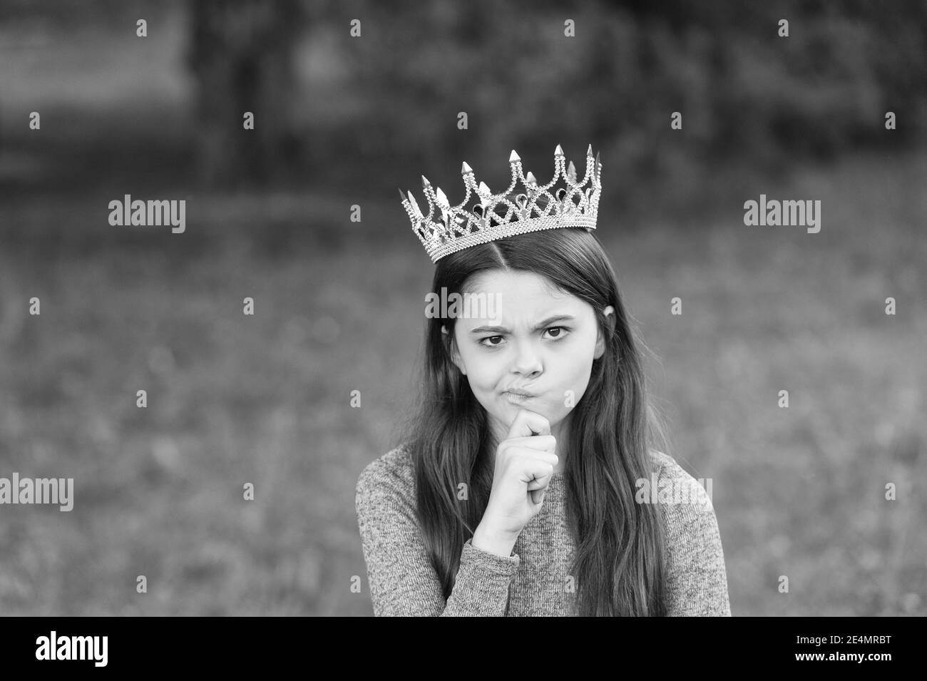 Cute girl golden crown outdoors green nature background, grumpy ...