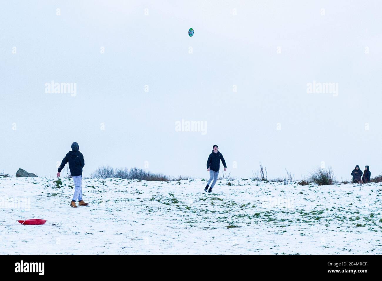 Bridgend, UK. 24th Jan, 2021. Two youngsters kick a rugby ball on the ...