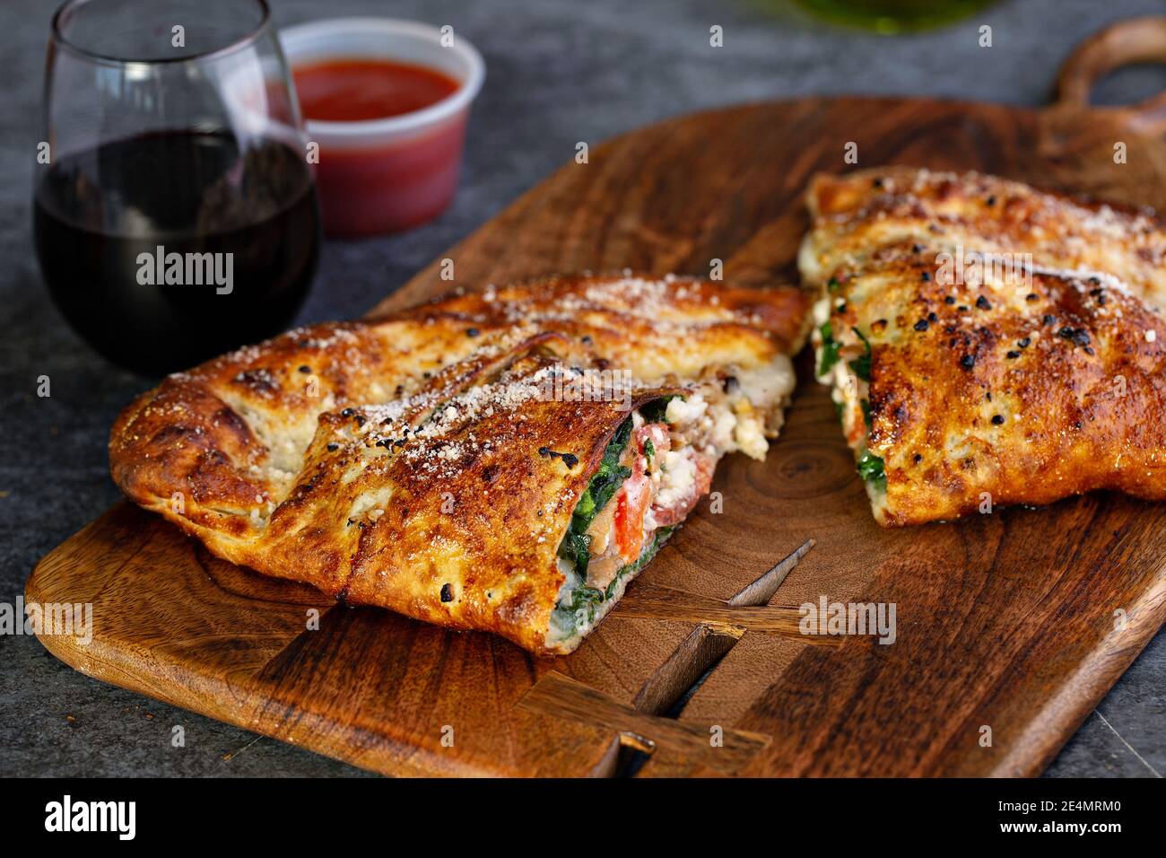 Traditional calzone cut in half Stock Photo - Alamy
