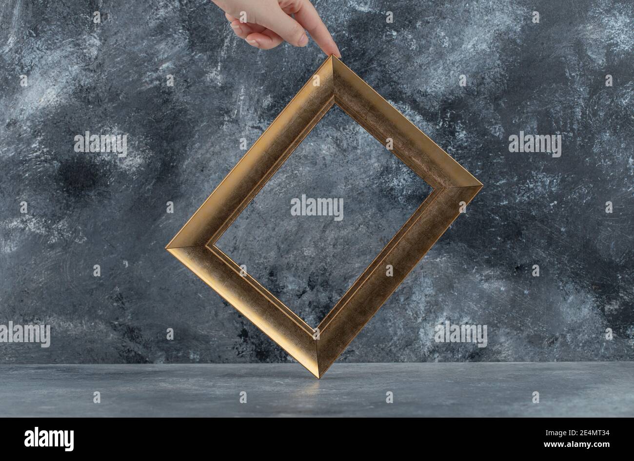 Female hand touching picture frame on marble background Stock Photo - Alamy