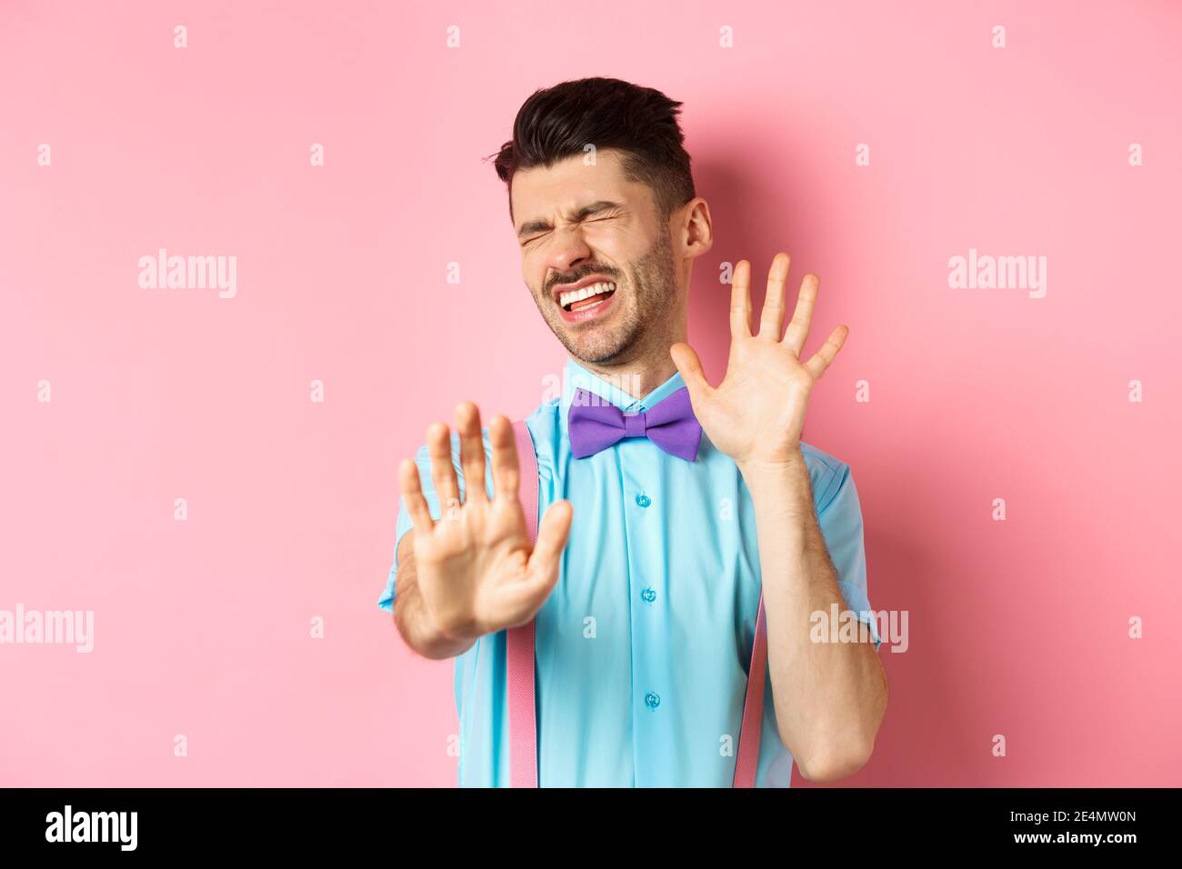 Crying guy asking to stop, raising hands up in defense, protecting ...