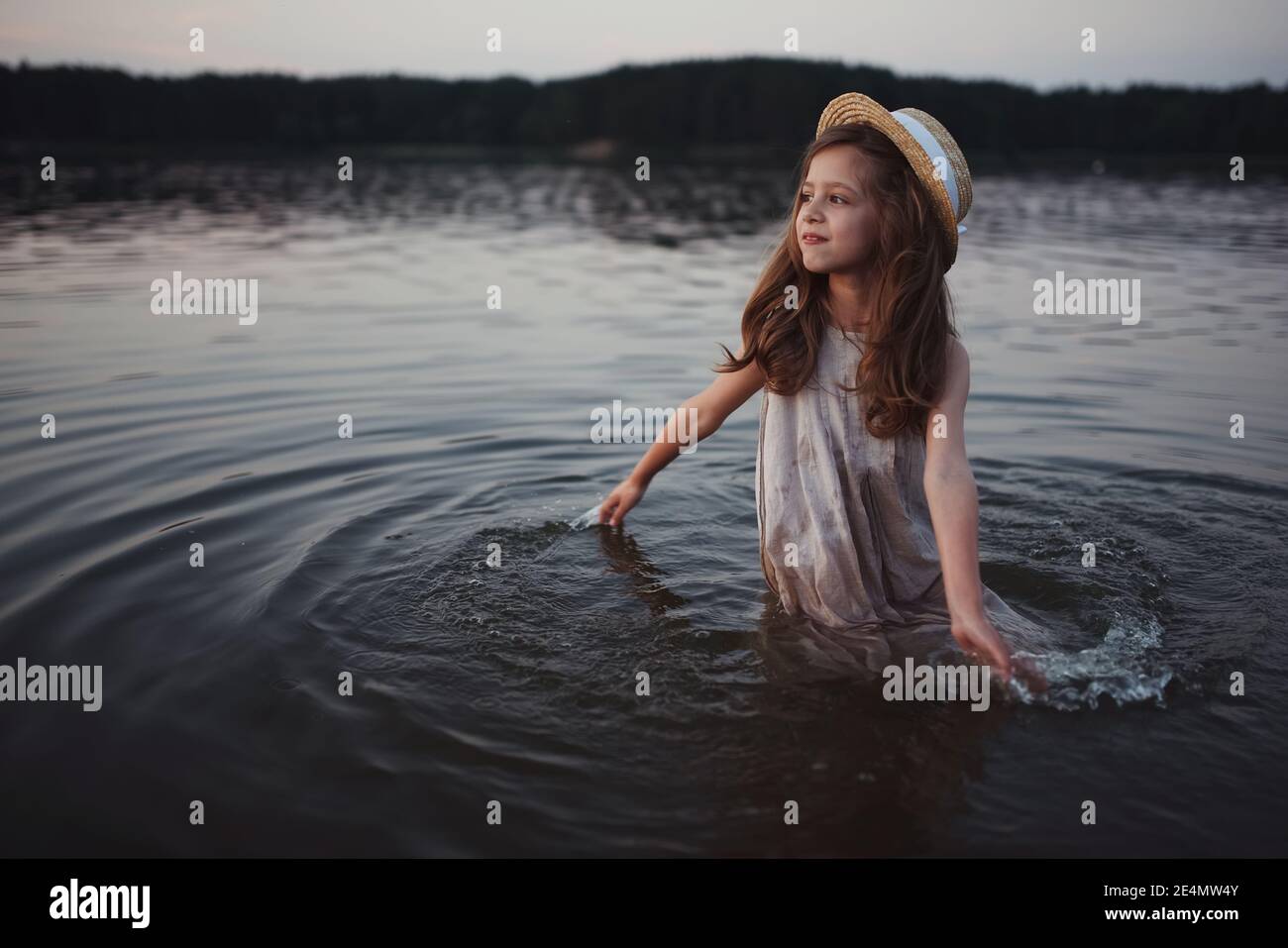 little cute girl with long hair on the lake Stock Photo - Alamy