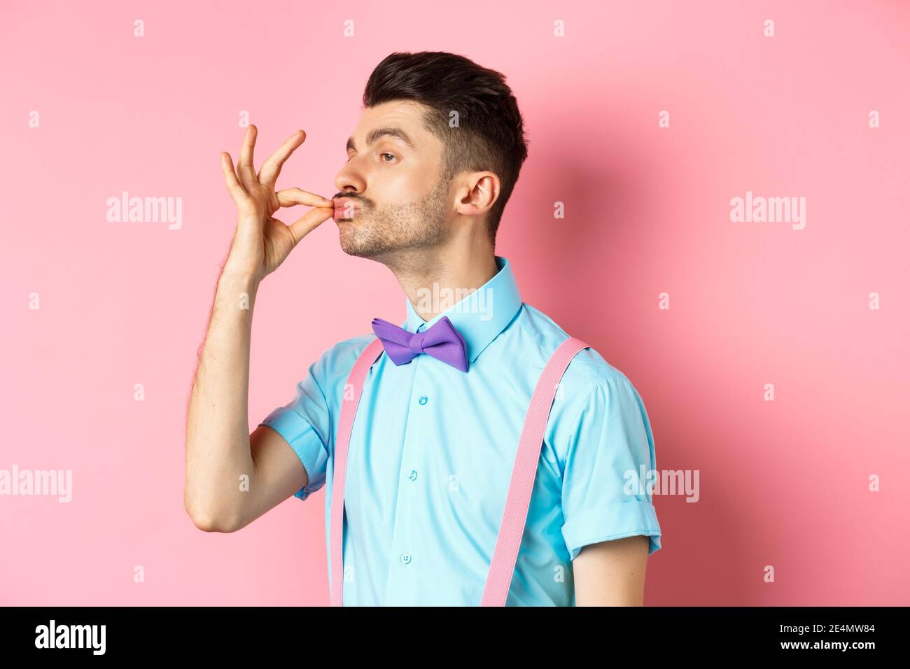 Profile of funny guy touching his french moustache and pucker lips like ...