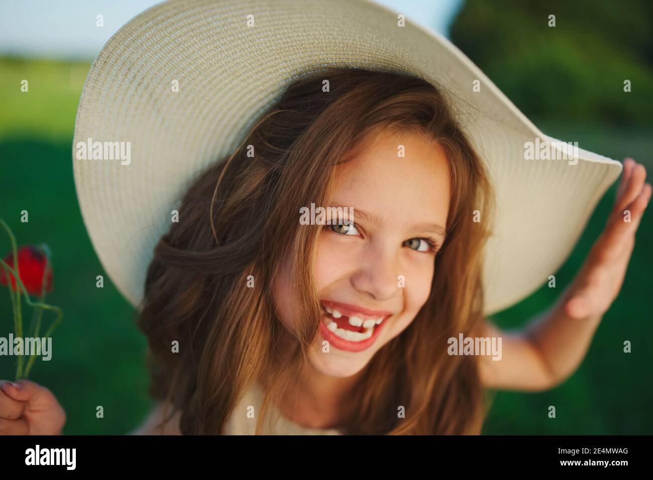 cute little girl in meadow with red poppies Stock Photo - Alamy