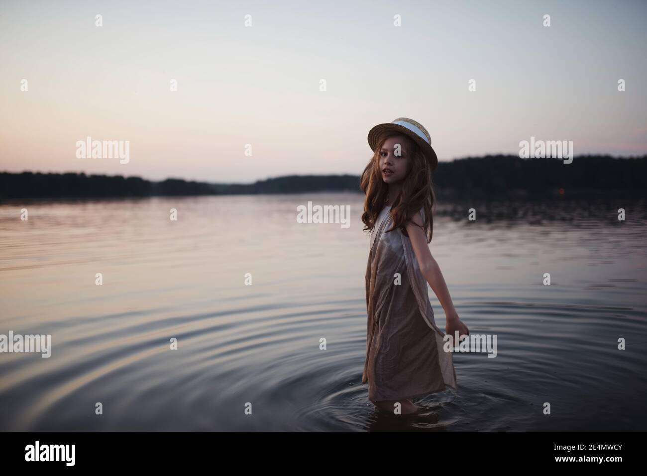 little cute girl with long hair on the lake Stock Photo - Alamy
