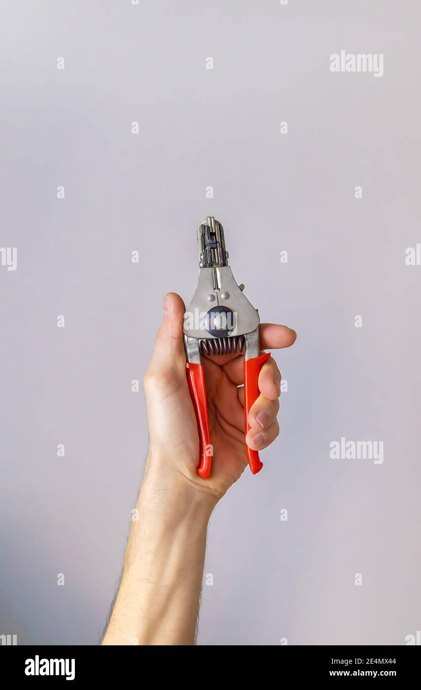electrical pliers in the hands of a male isolate. Selective focus ...
