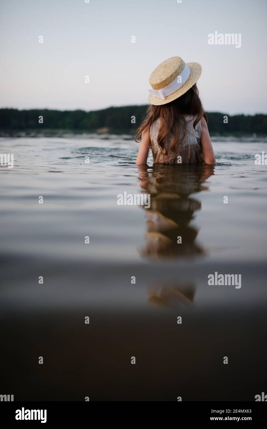 little cute girl with long hair on the lake Stock Photo - Alamy