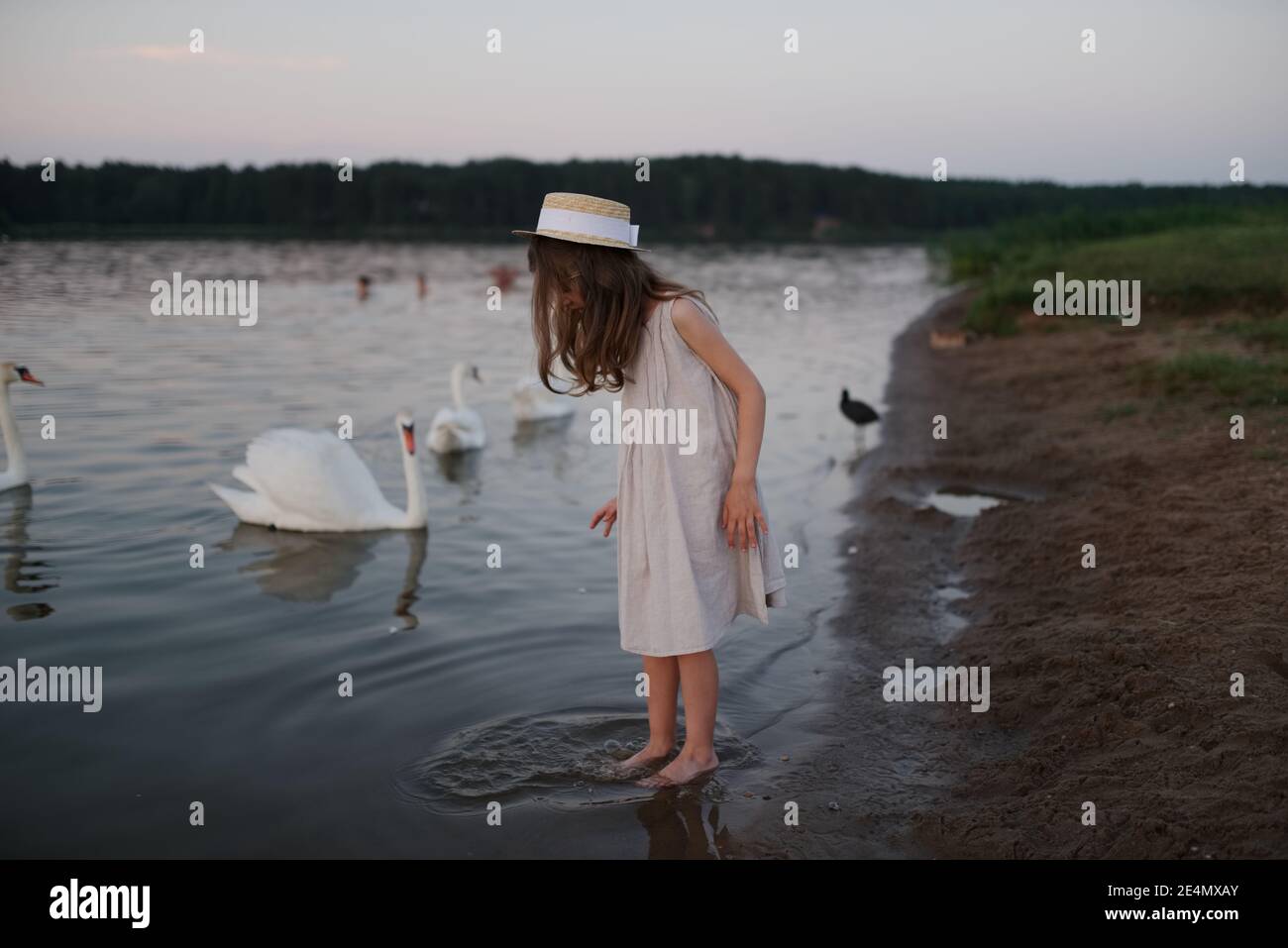 little cute girl with long hair on the lake Stock Photo - Alamy