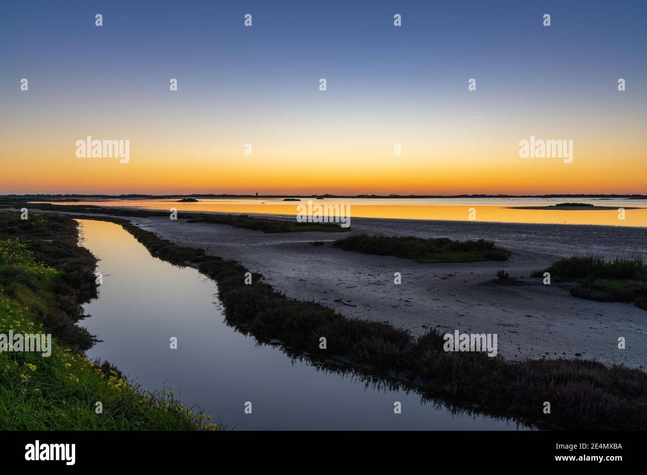 Beautiful nightfall with a colorful sky over wetlands and canals nature ...