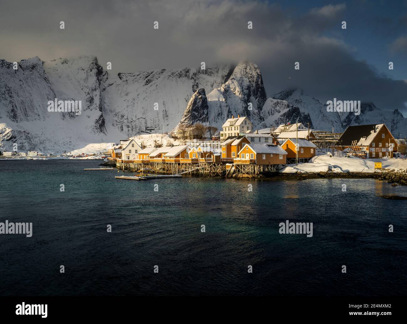 Winter sunrise on the traditional fishing huts in Kvalvika, near Reine ...