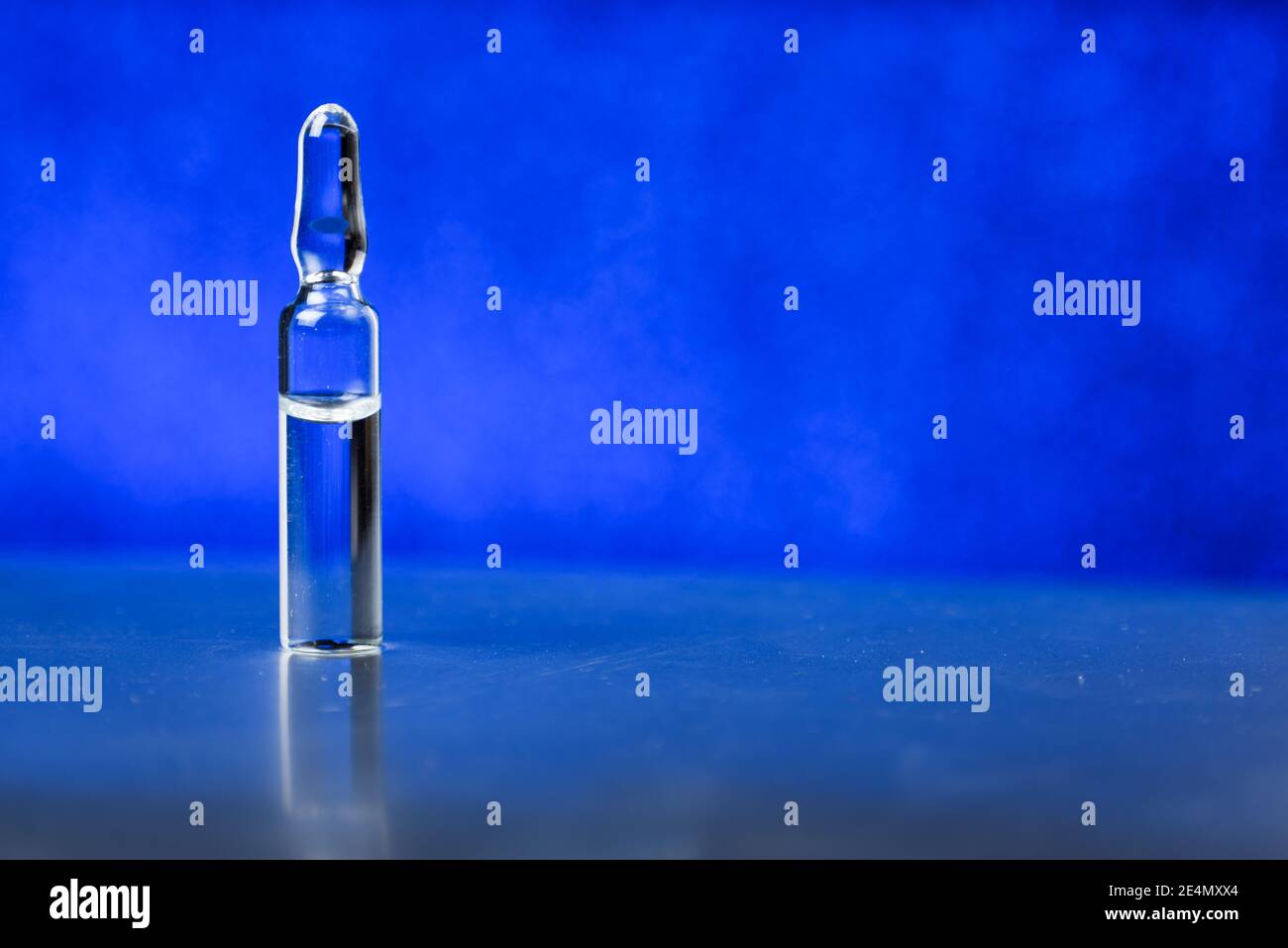 Medical ampoule for injection on blue. Medicine for vaccination Stock ...