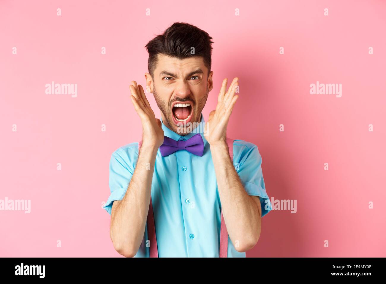 Angry man screaming like crazy, shaking hands and stare furious at ...