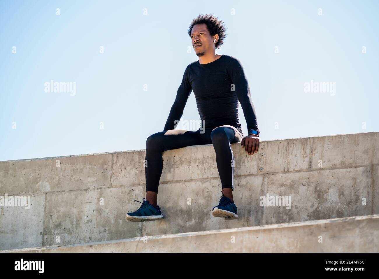 Athletic man relaxing after work out outdoors Stock Photo - Alamy