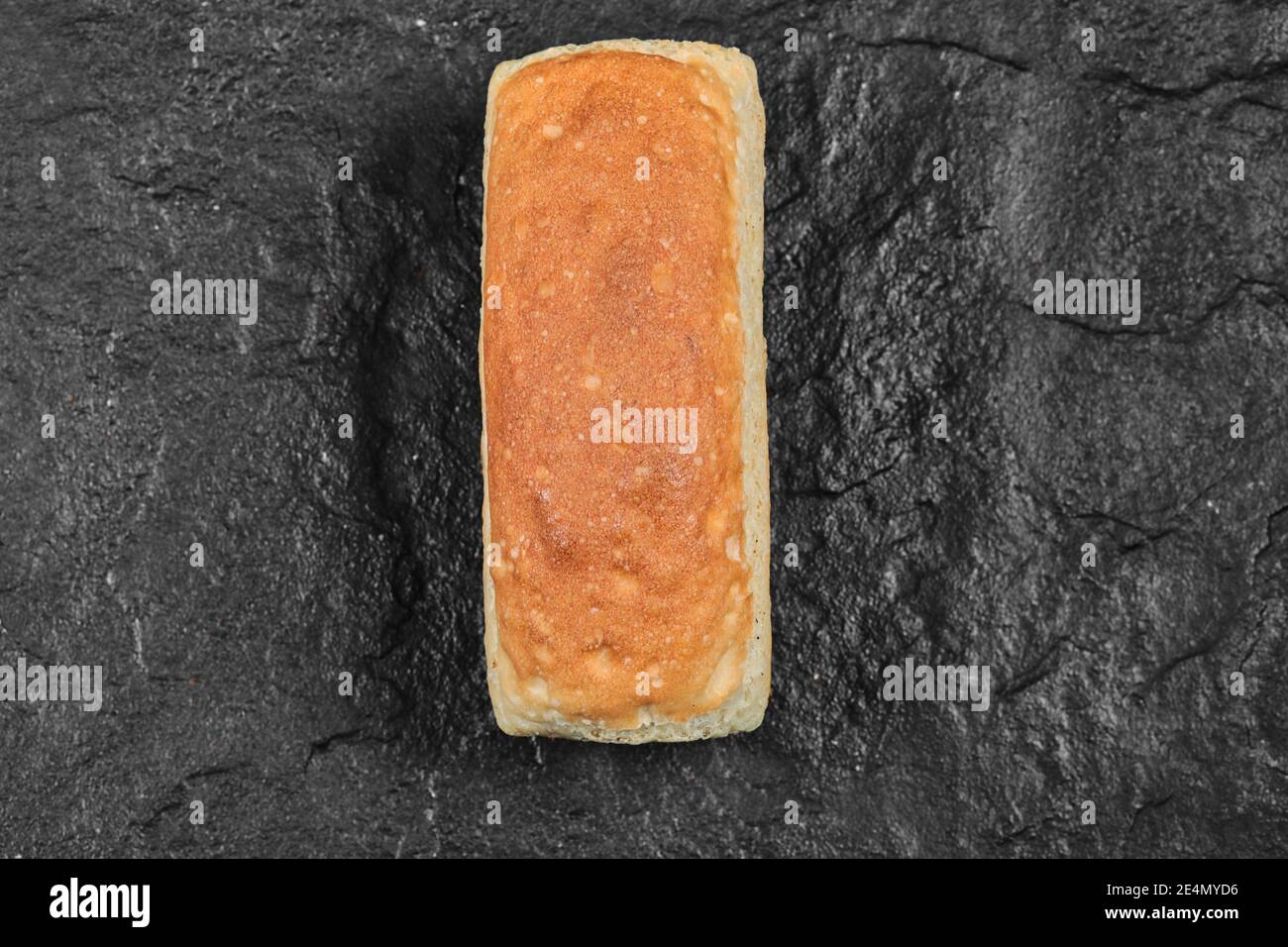 Square loaf of bread isolated on dark background Stock Photo - Alamy