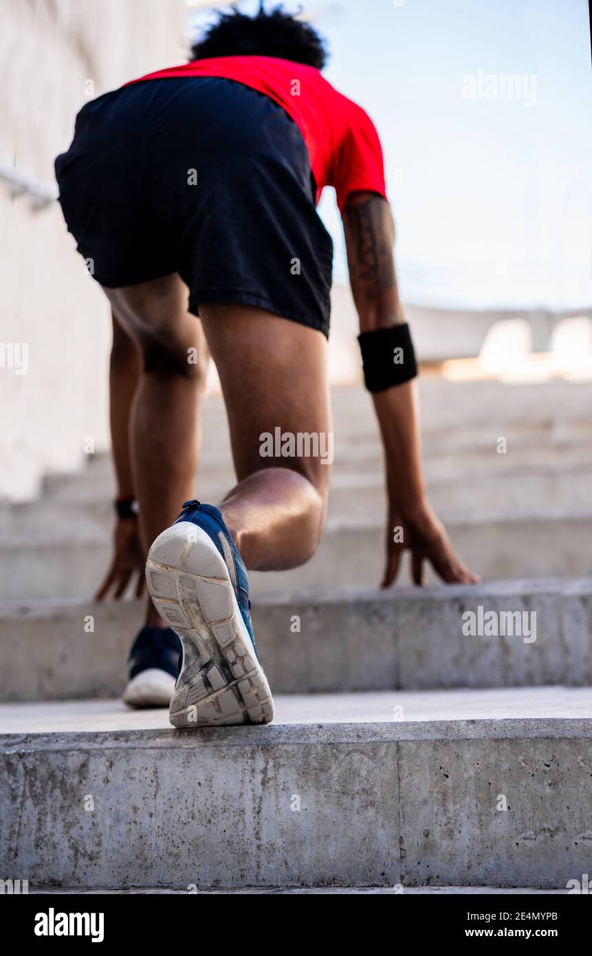 Athlete man in start position preparing to run outdoors Stock Photo - Alamy
