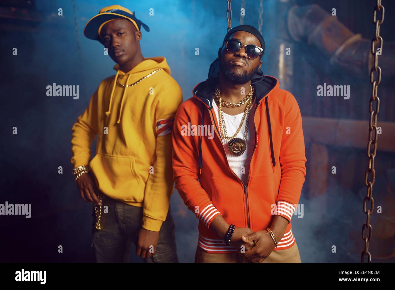Two stylish rappers poses in studio Stock Photo - Alamy