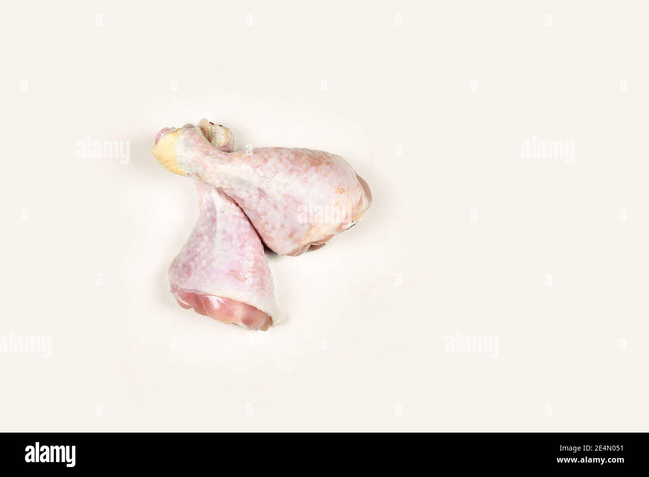 Raw chicken legs isolated on white background Stock Photo - Alamy