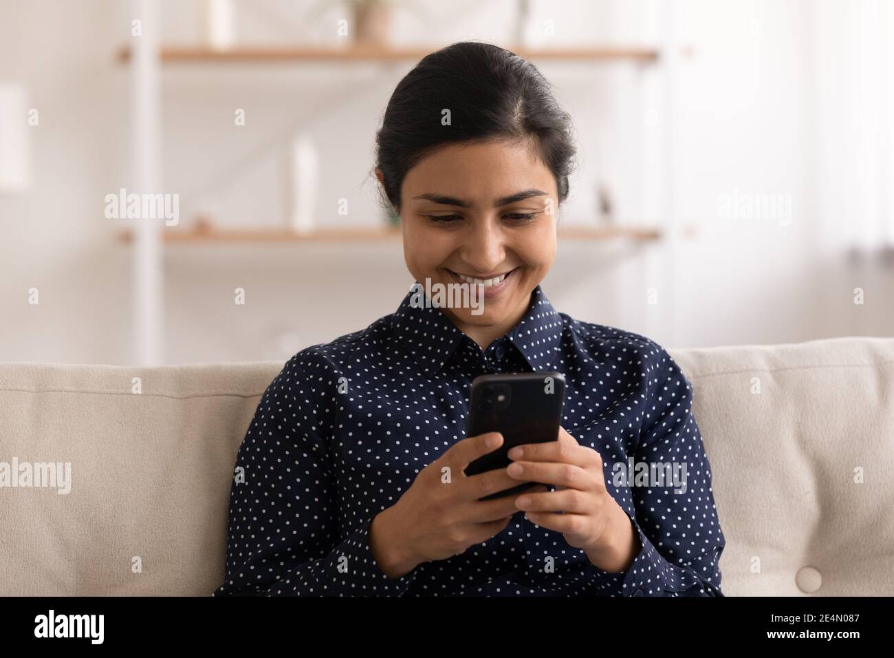 Content hindu woman reading email in convenient app on cell Stock Photo ...