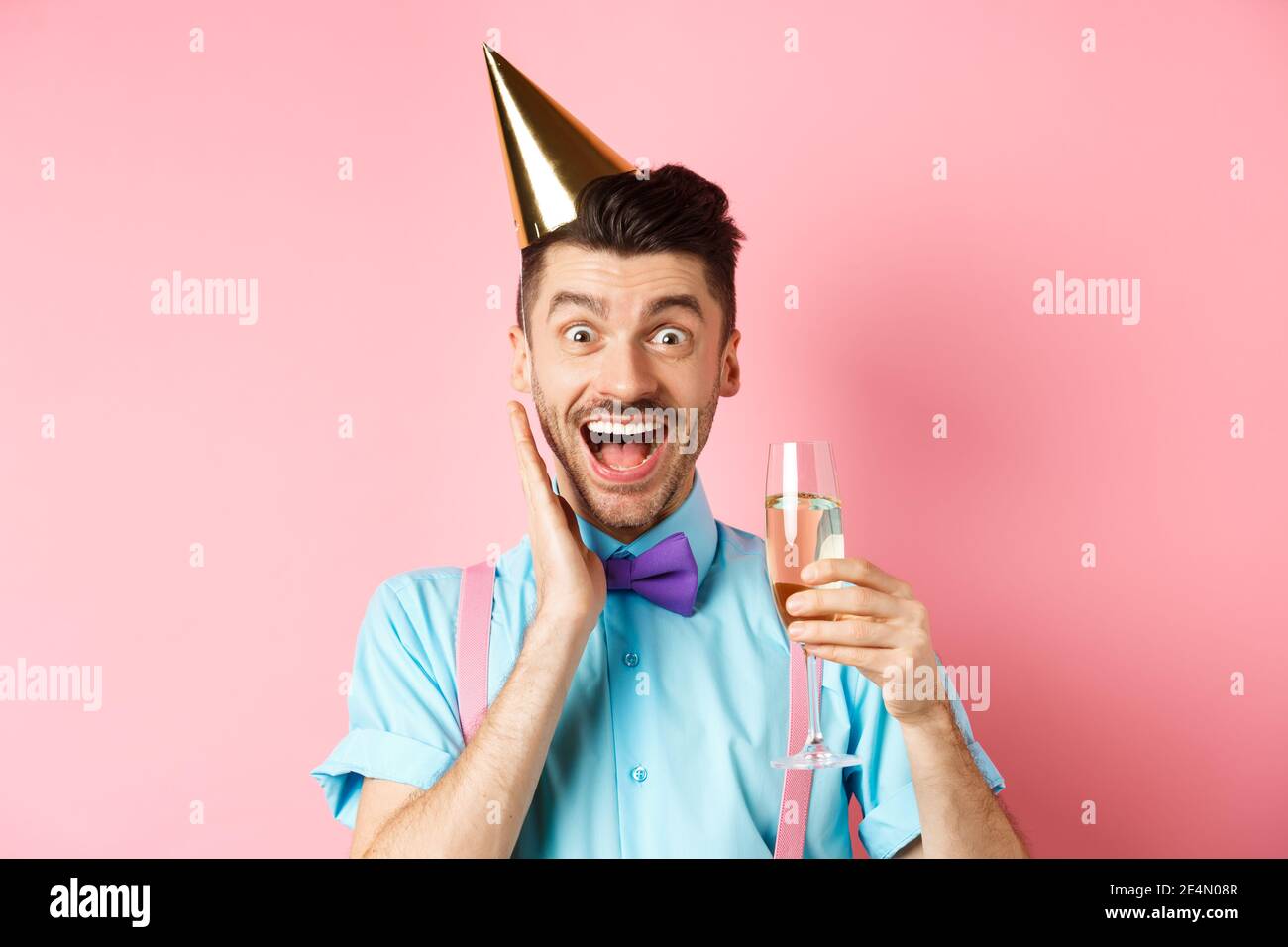 Holidays and celebration concept. Funny young man in birthday hat ...