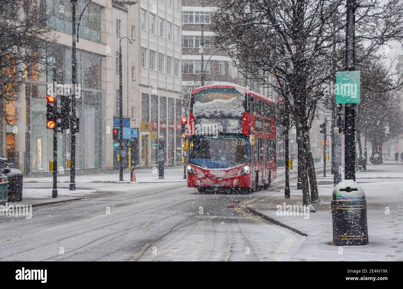 A bus drives through Oxford Street covered in snow. Londoners woke up ...