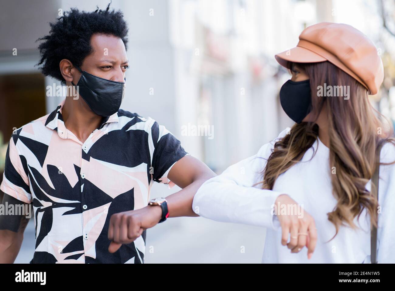Couple tap each other with elbows to say hello Stock Photo - Alamy