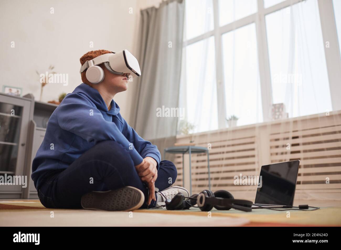 Boy sitting floor side view hi-res stock photography and images - Alamy