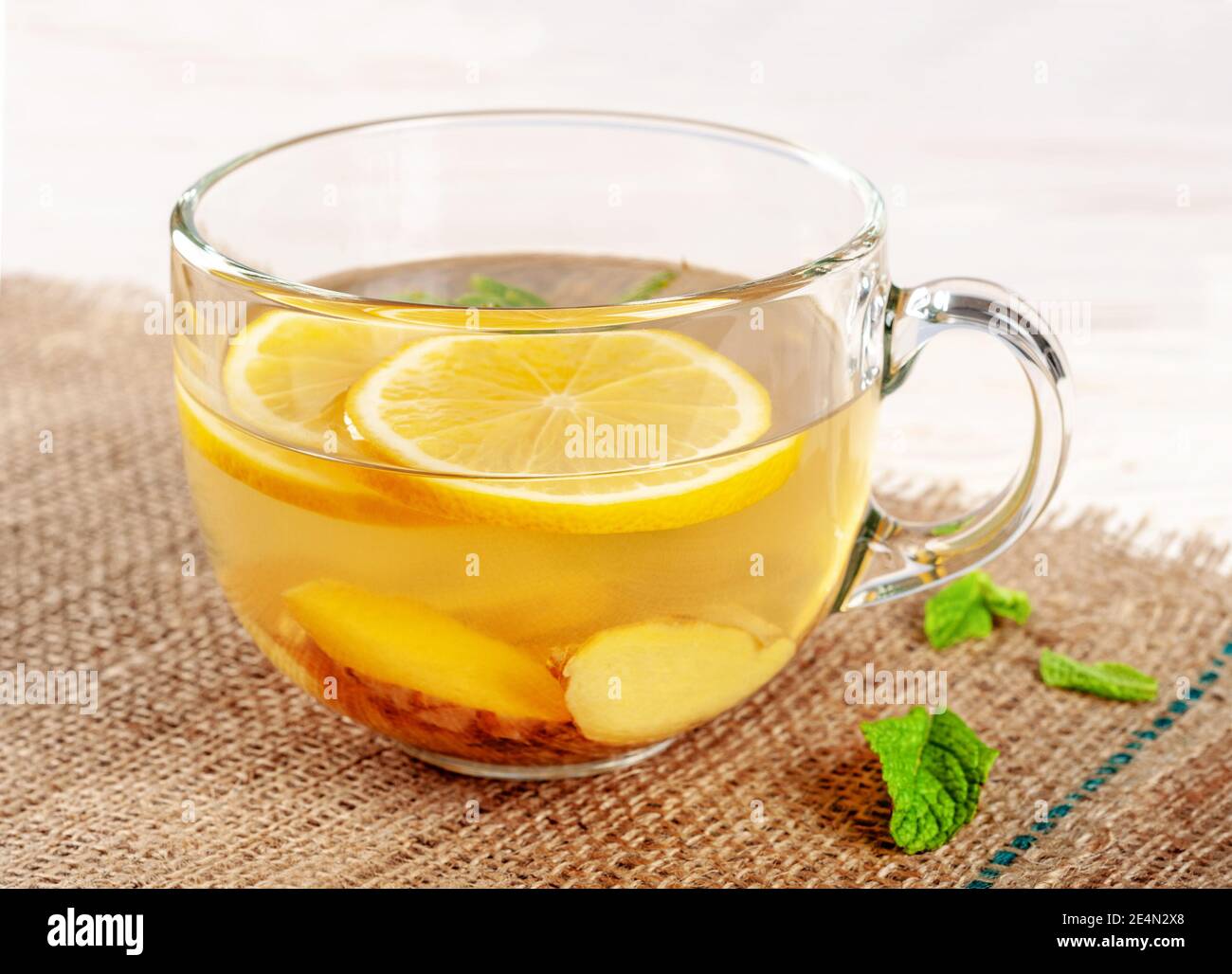 Glass cup of hot ginger tea with peppermint and lemon Stock Photo - Alamy