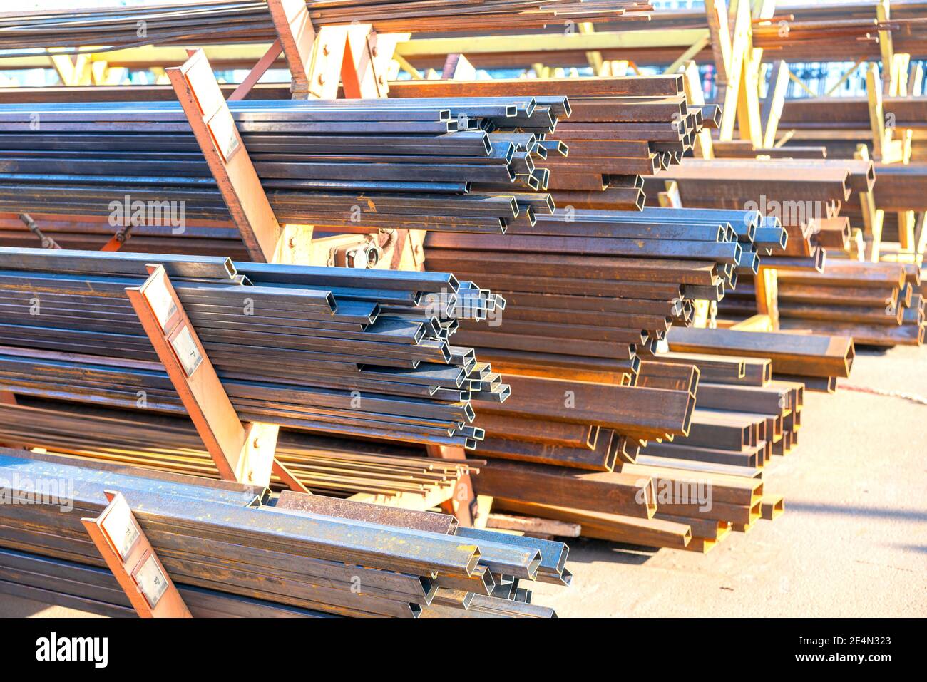 stack of steel pipe and metal beams on rack. metal pipes, profiles ...