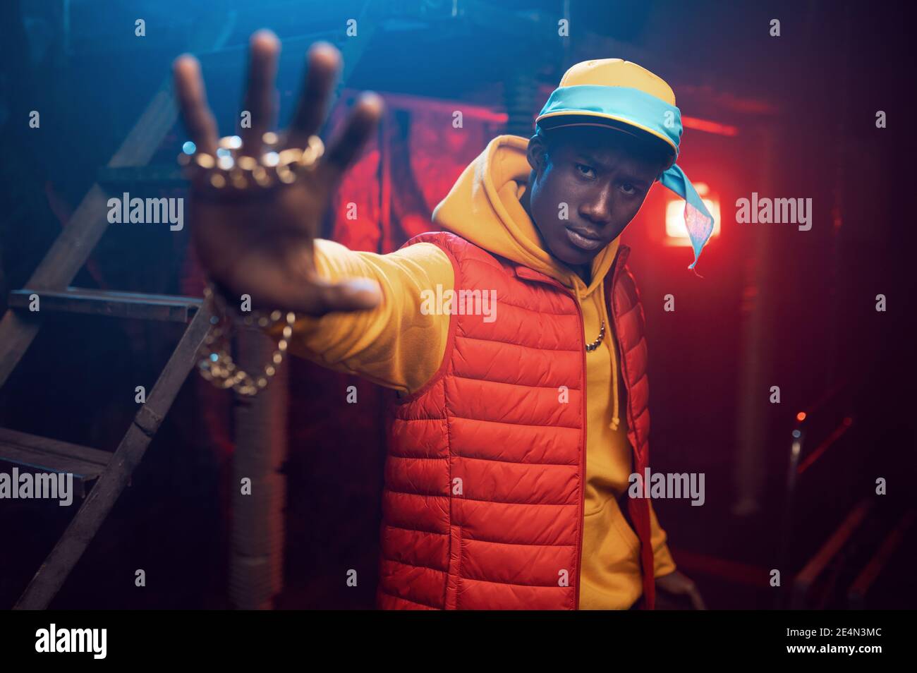 Young serious rapper poses in grunge studio Stock Photo - Alamy