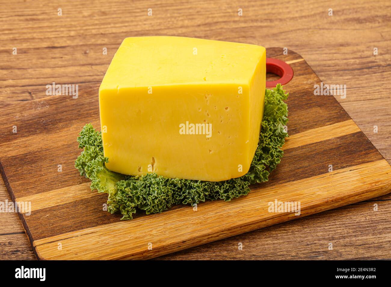 Yellow tilsiter cheese dairy product brick Stock Photo - Alamy