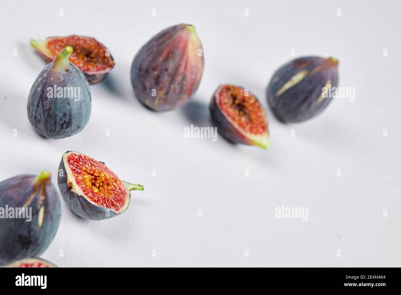Whole figs and fig slices on a white background Stock Photo - Alamy