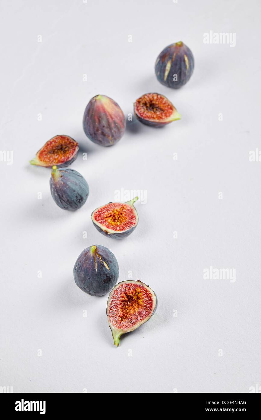 Whole fig and fig slices on a white background Stock Photo - Alamy