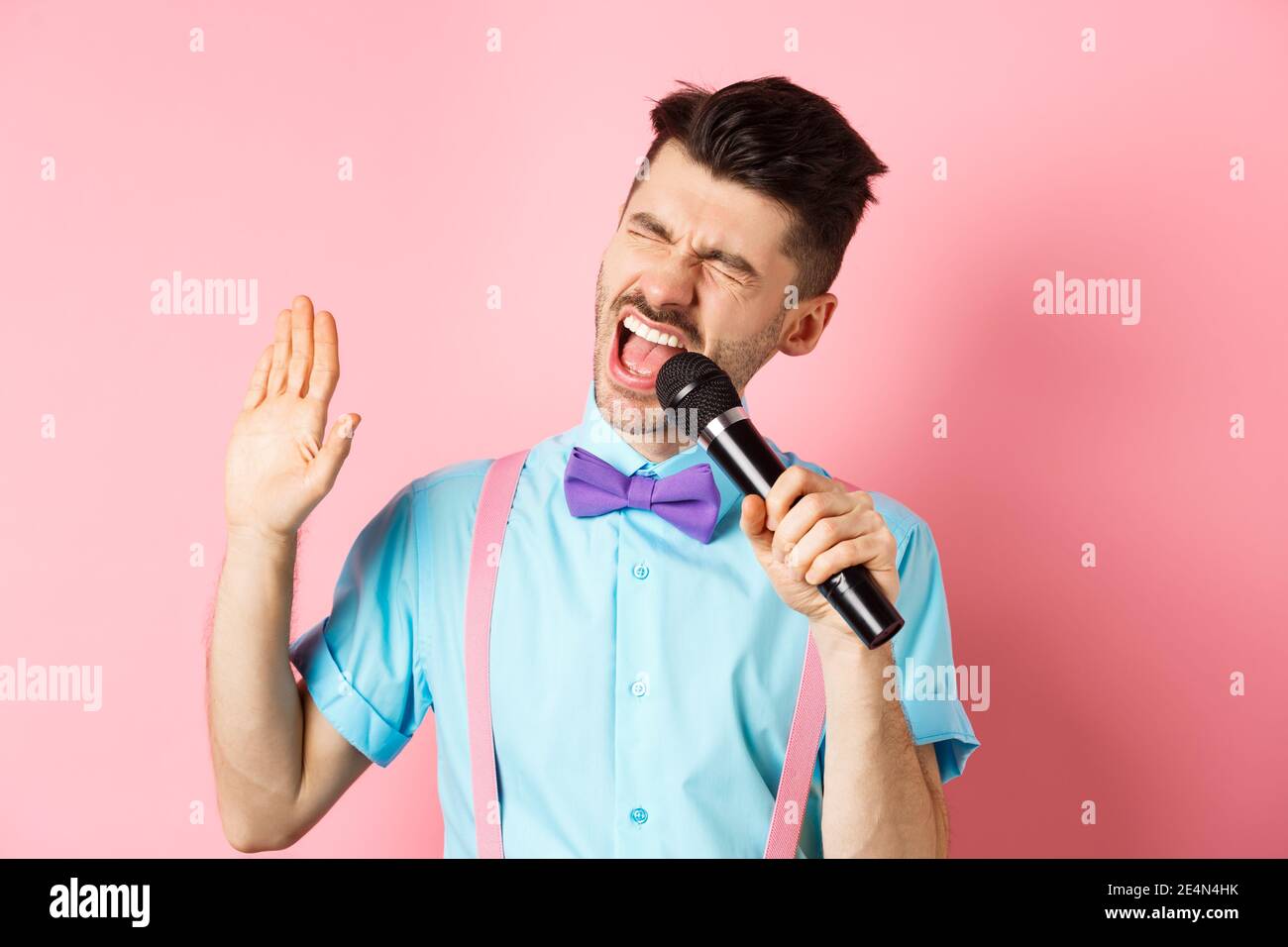 Party and festive events concept. Funny guy performs a song, singing ...