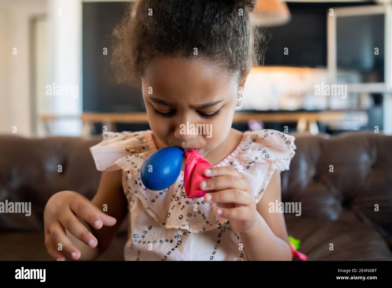 Little girl playing with balloons at home Stock Photo - Alamy