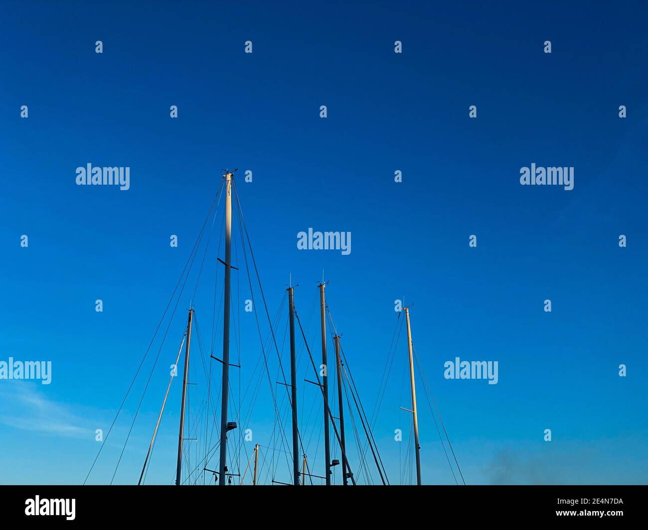 An aerial shot of yacht masts under blue sky Stock Photo - Alamy