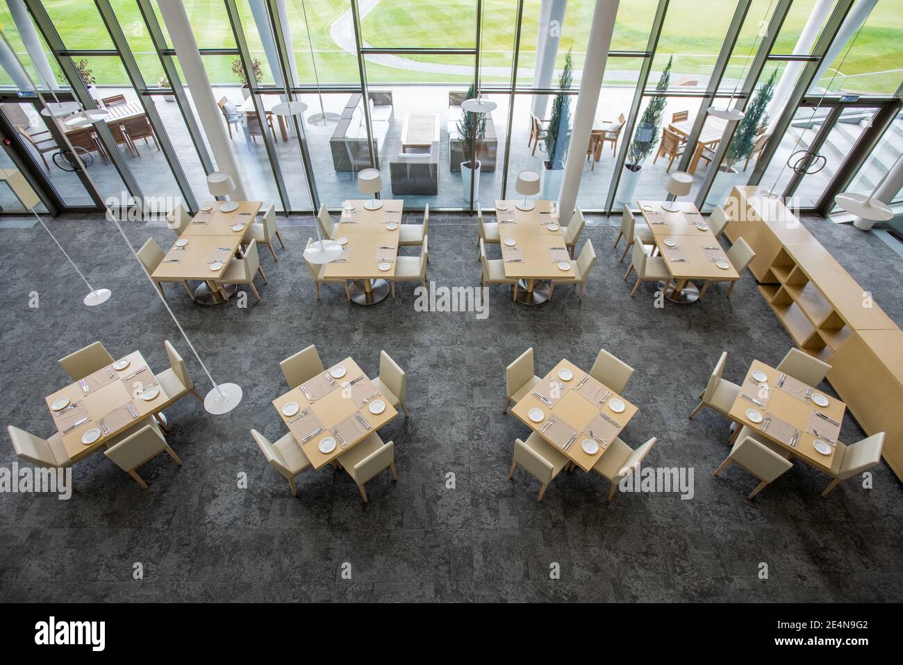 Overview of two rows of tables served for guests in large luxurious ...