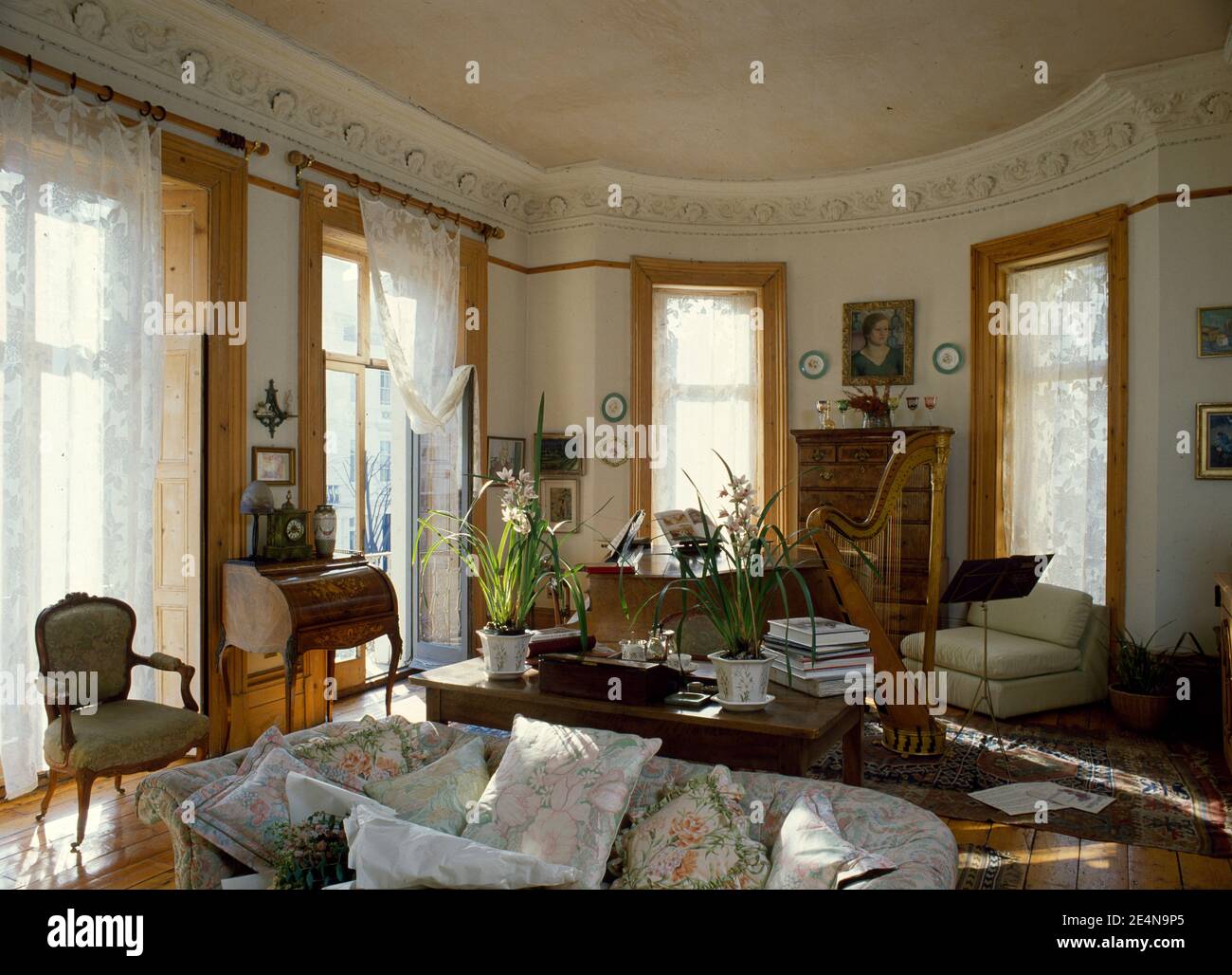 Regency livingroom with large sash floor to ceiling windows covered ...