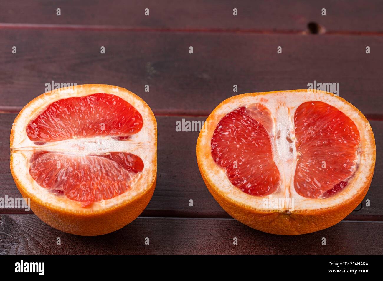 Close up view of grapefruit isolated on wood background. Healthy eating ...
