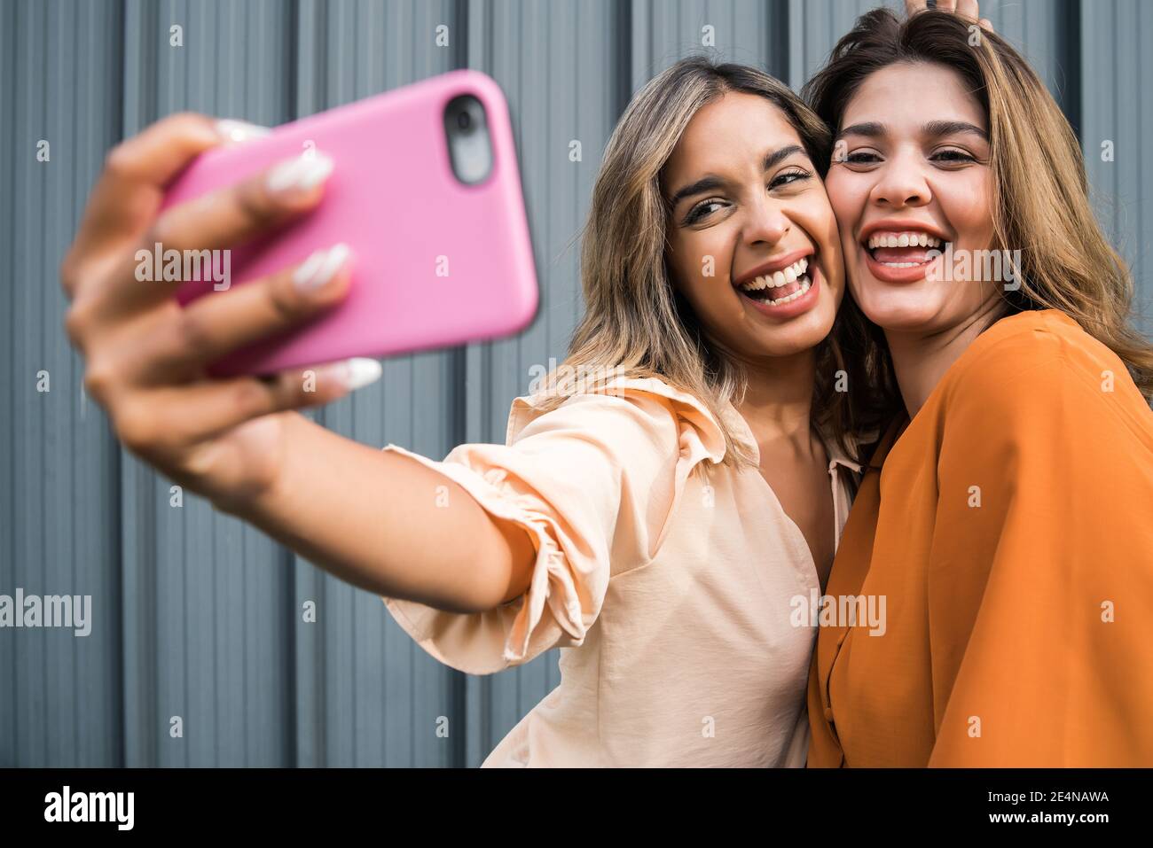Two friends taking selfie with phone outdoors Stock Photo - Alamy