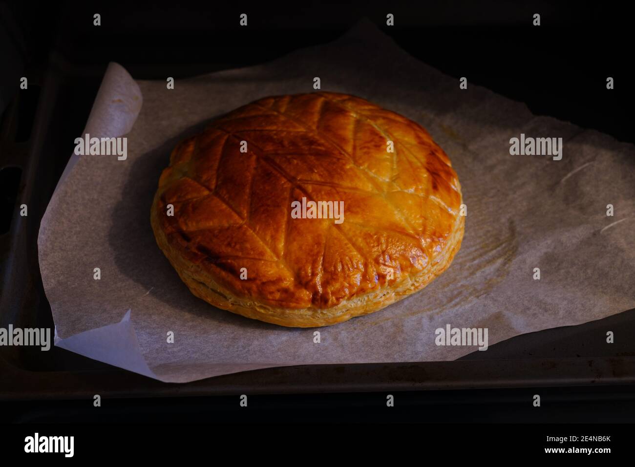 A French Galette des Rois (Kings cake) puff pastry cake baking in the ...