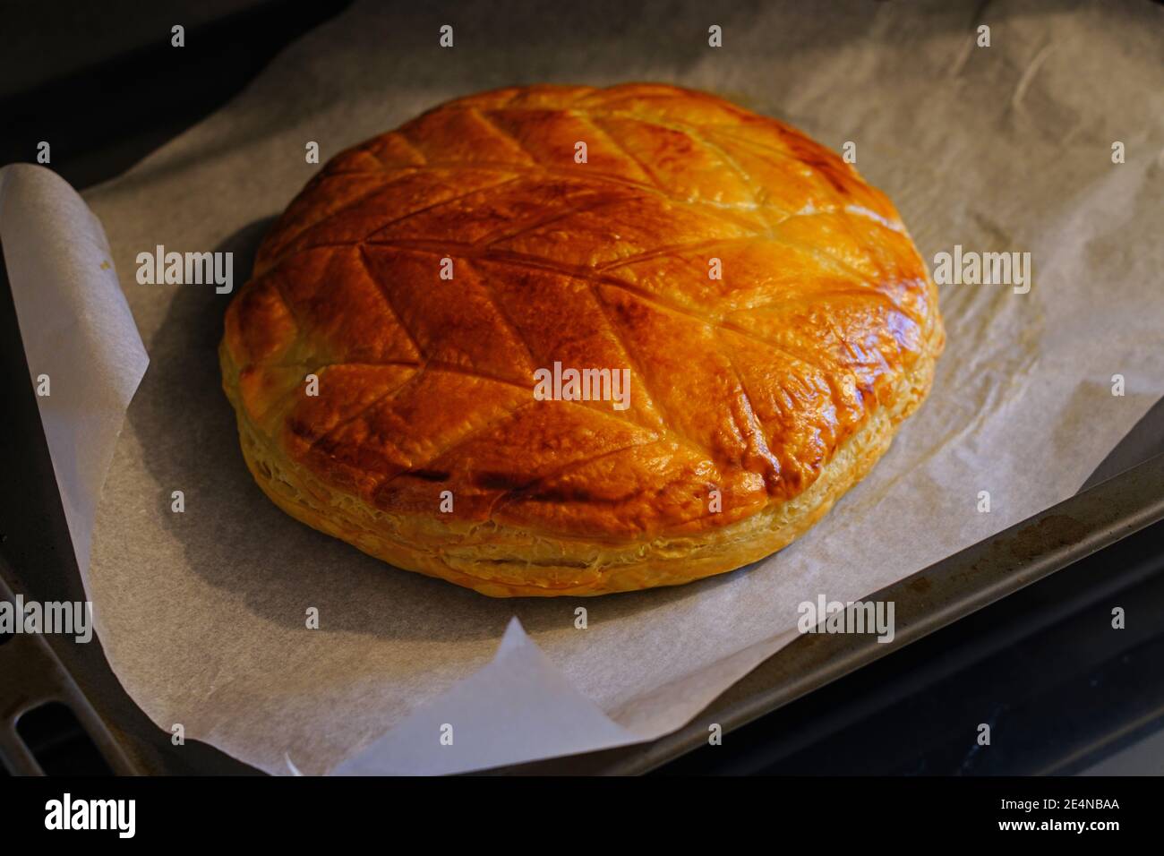 A French Galette des Rois (Kings cake) puff pastry cake baking in the ...