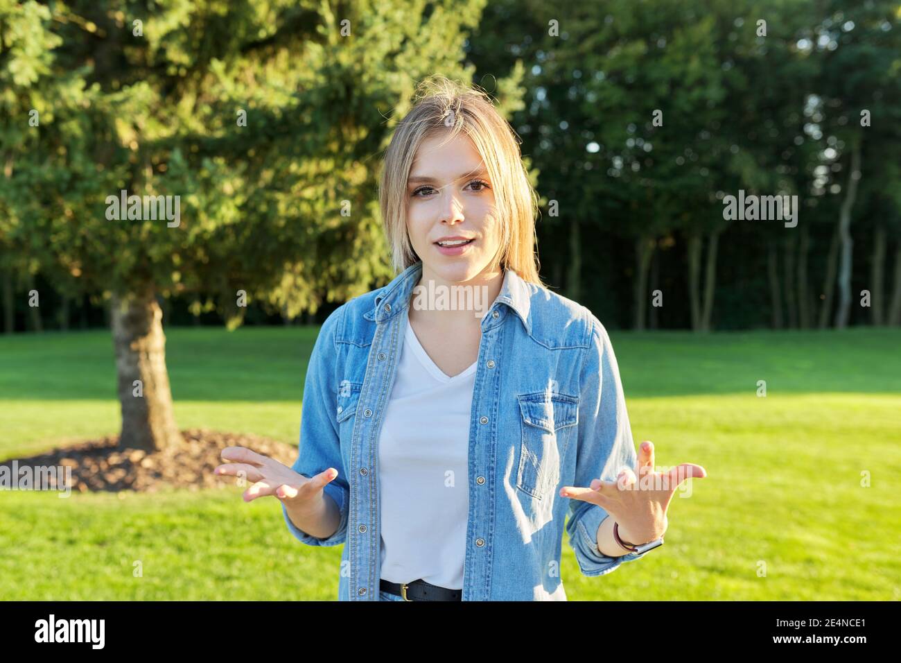 Talking gesturing young woman student looking at the camera Stock Photo ...