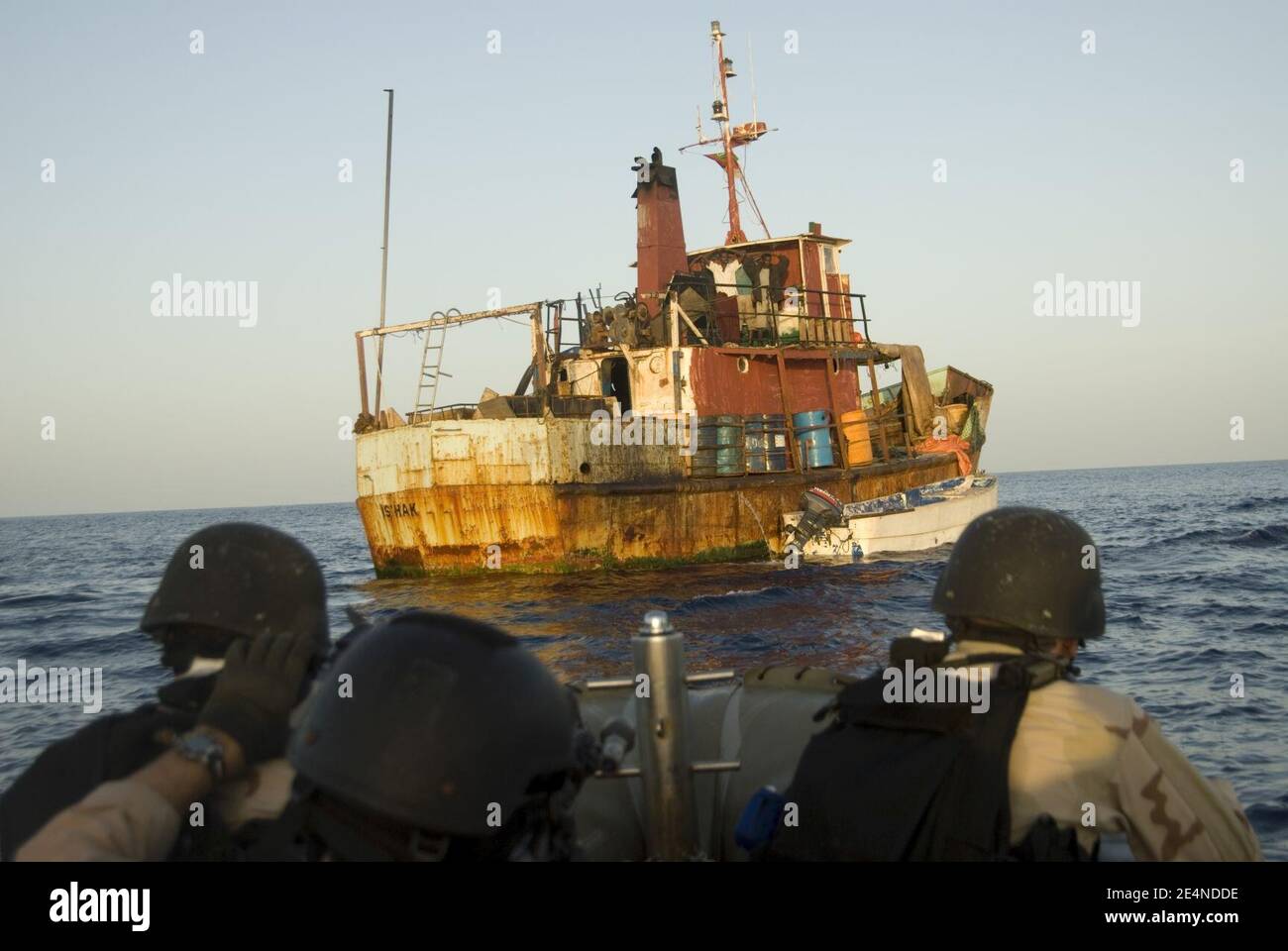 Members of a visit, board, search and seizure (VBSS) team approach a ...