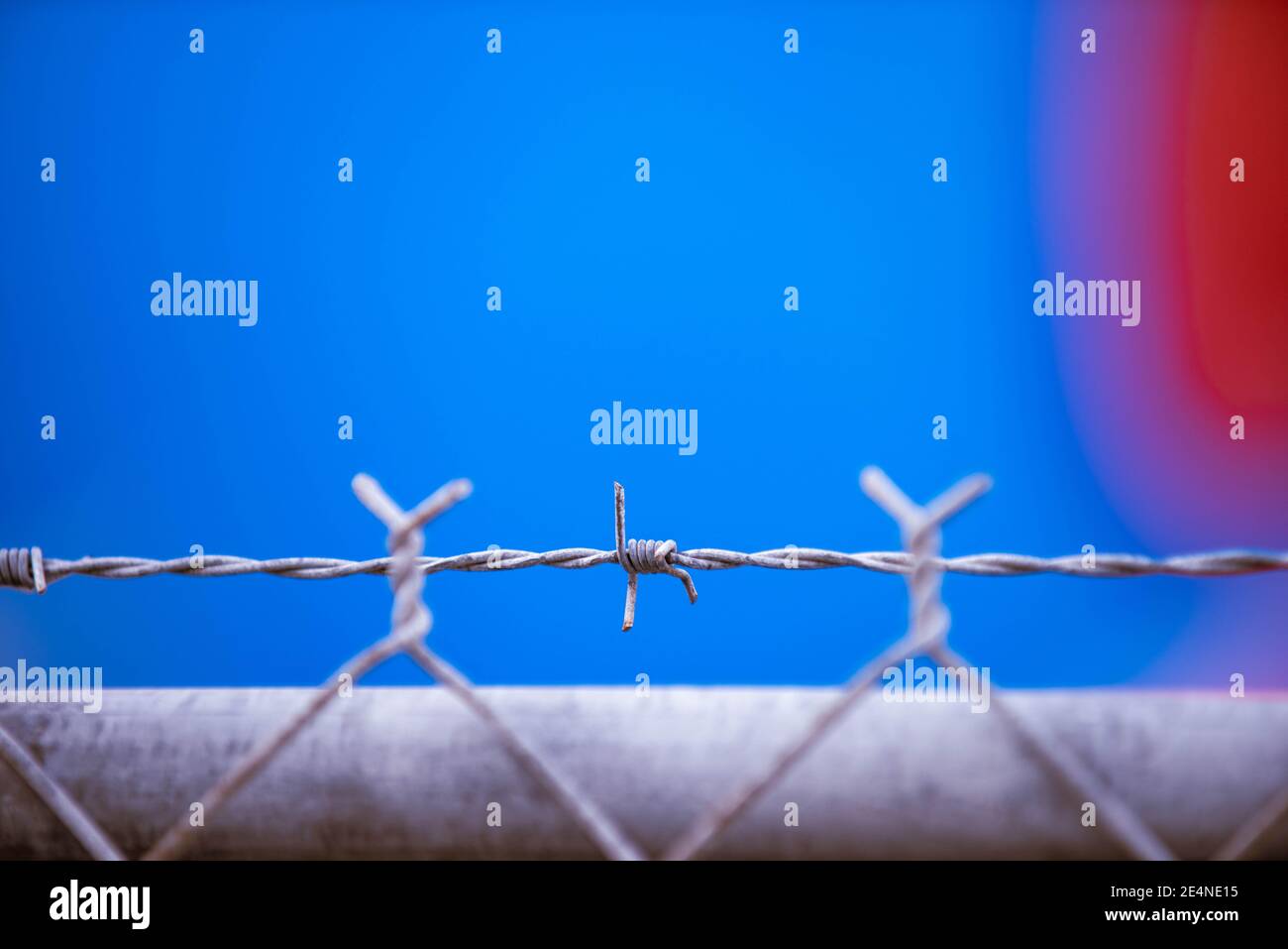 barbed wire fence with painted background Stock Photo - Alamy