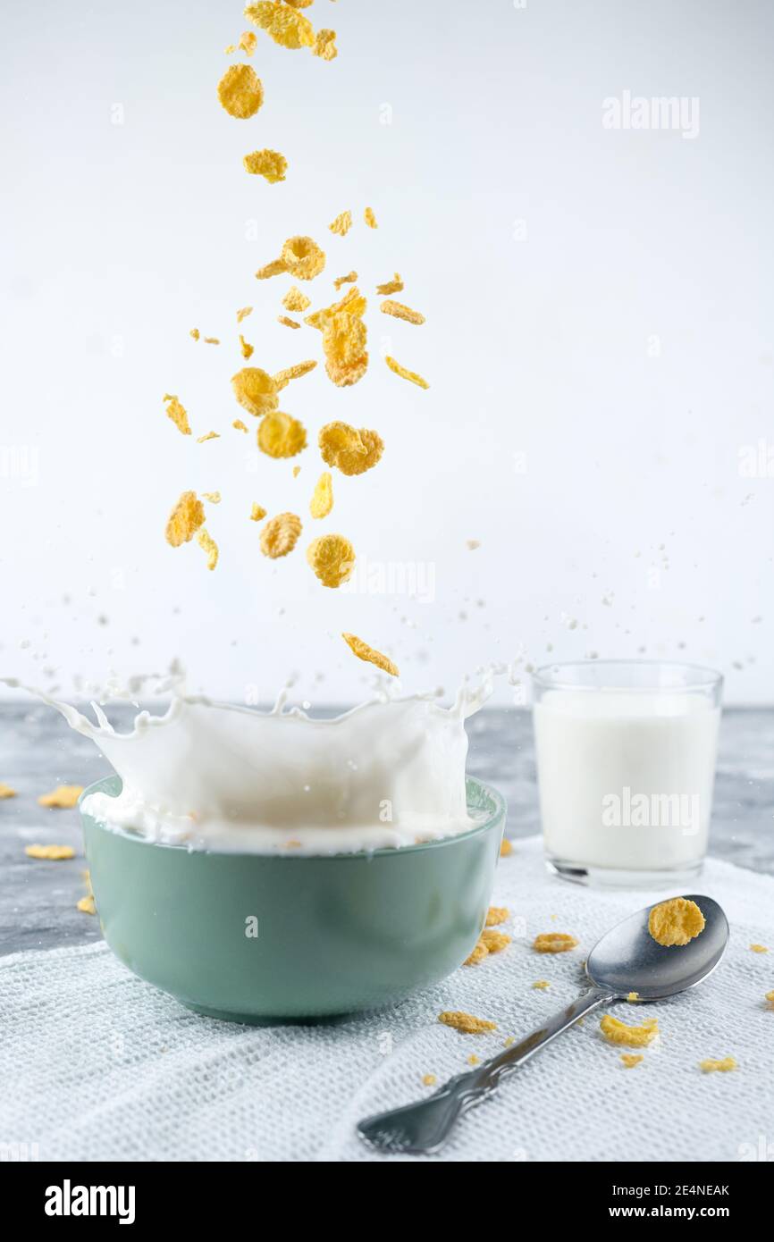 Healthy Breakfast-Cornflakes and Milk Splash on blue background Stock ...